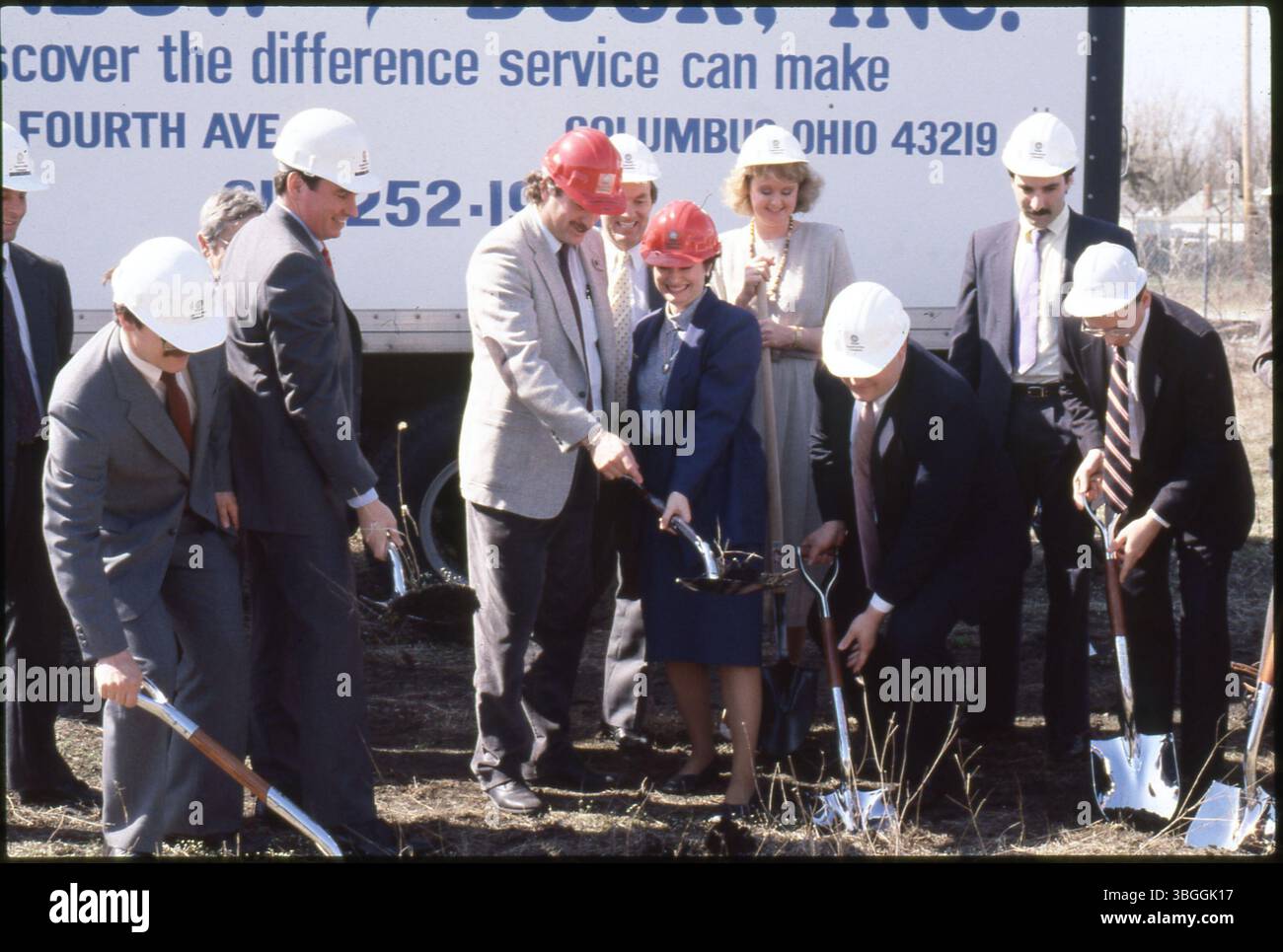 A groundbreaking ceremony in 1986, featuring two women in dresses and ...