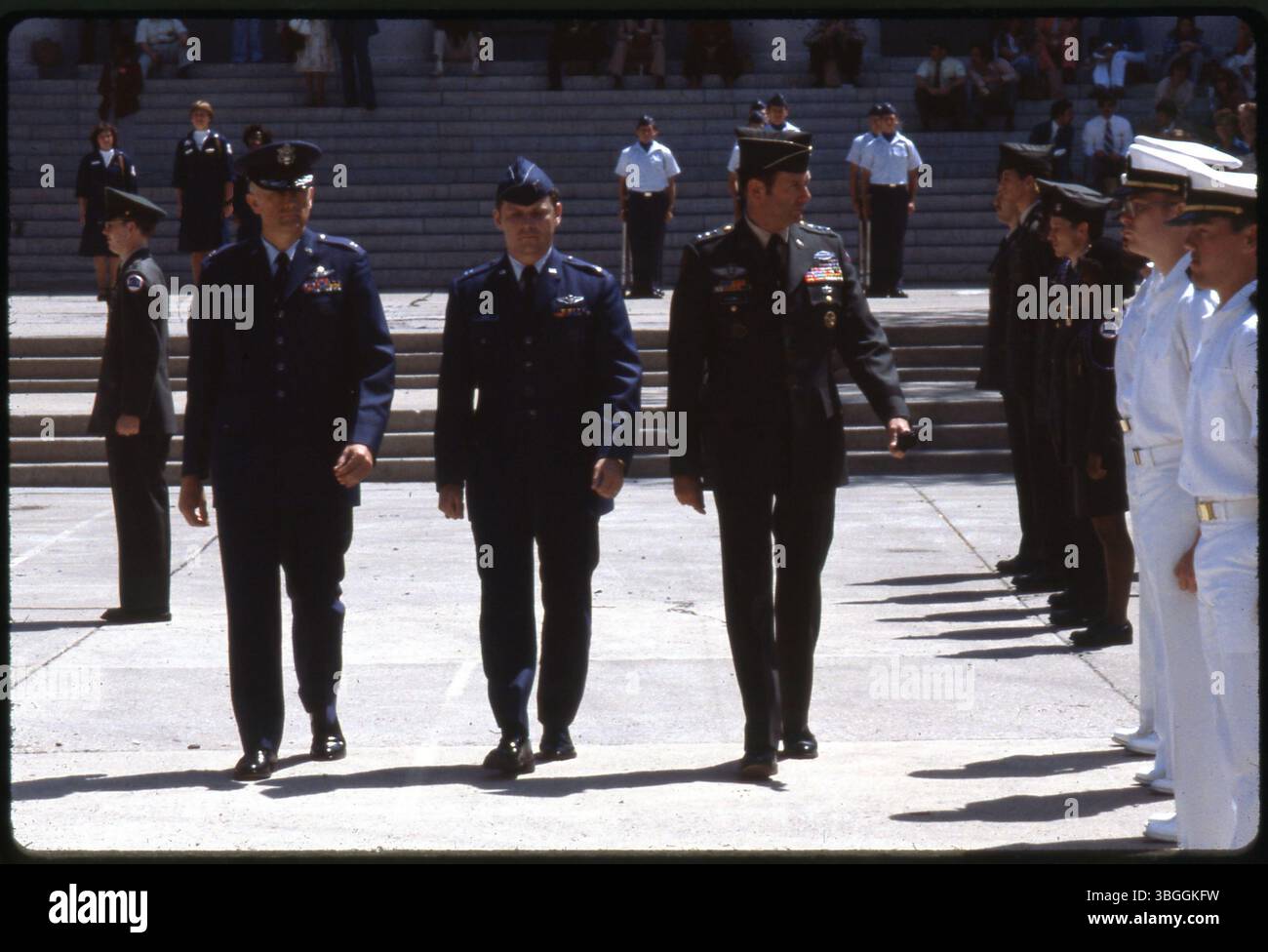 Three high-ranking male military officers walk in a row during an ...