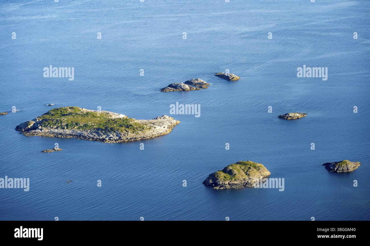 Small rocky islands in the sea, archipelago islands, near Henningsvaer ...