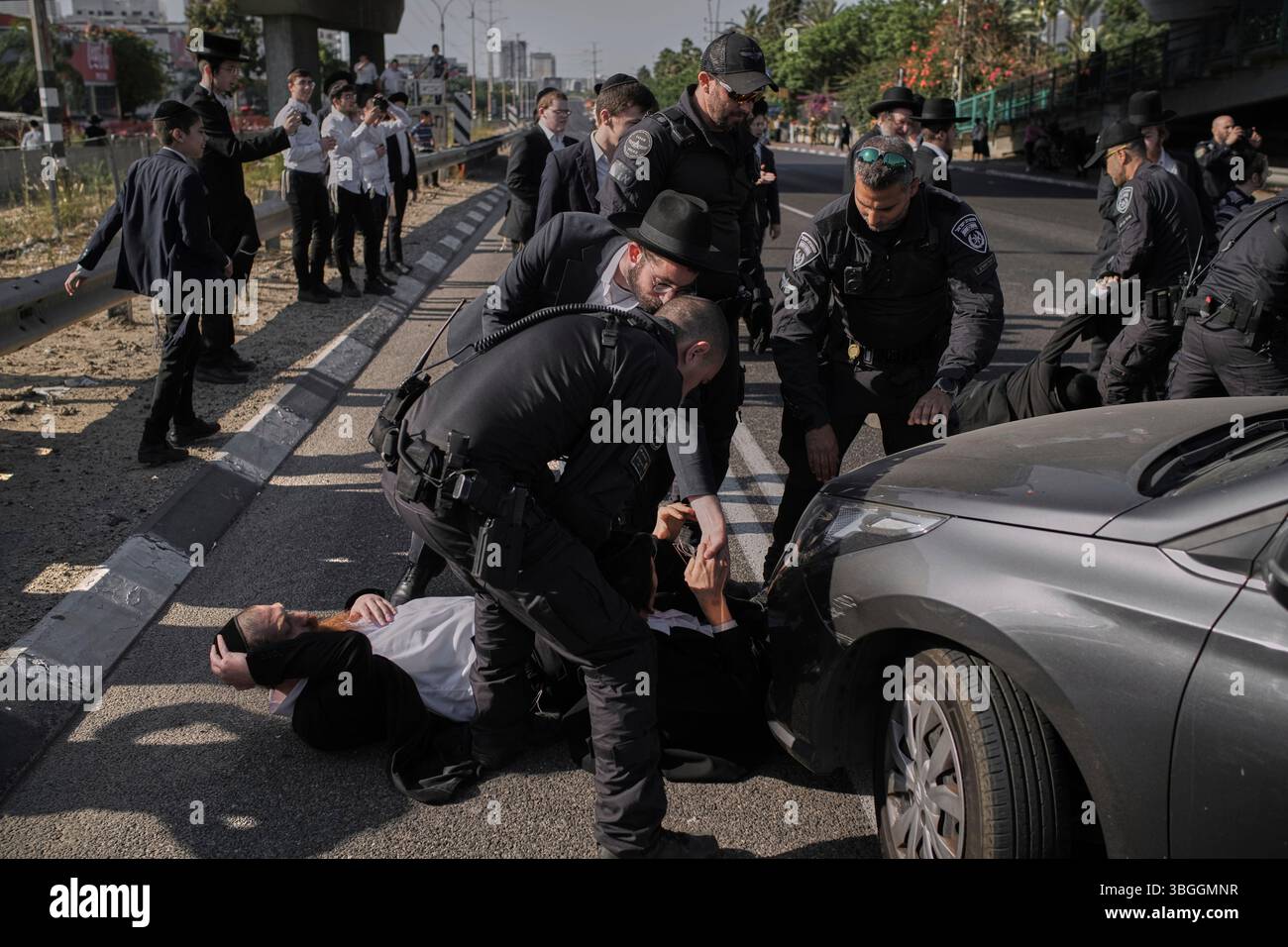 Israeli police officers disperse ultra-Orthodox Jewish men during a ...