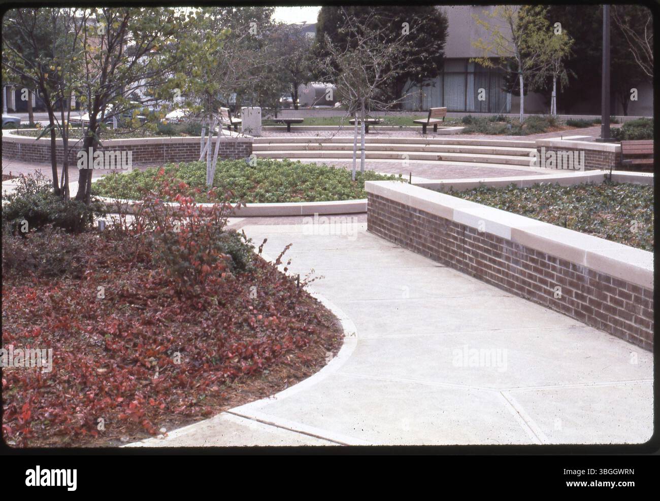 Small brick courtyard featuring benches and landscaping, possibly ...