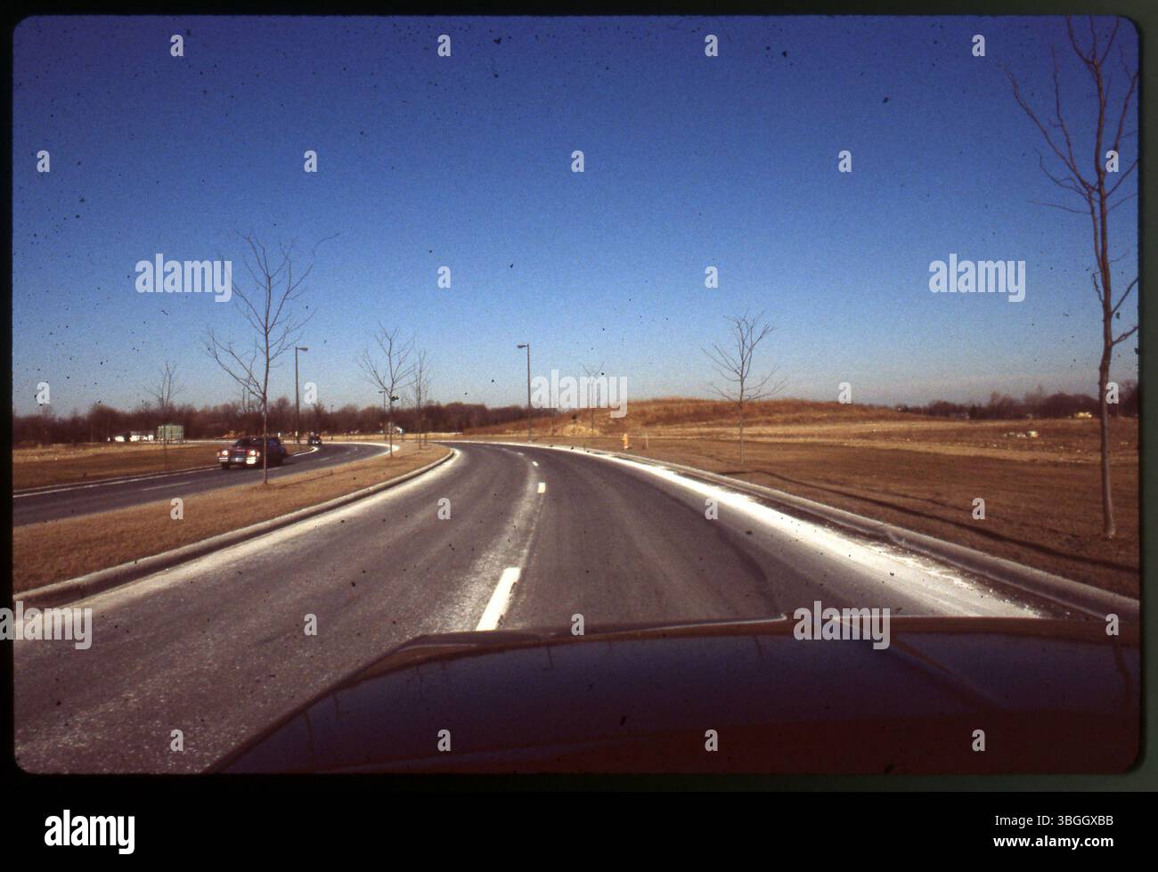 A divided road with two lanes in each direction, featuring a median ...