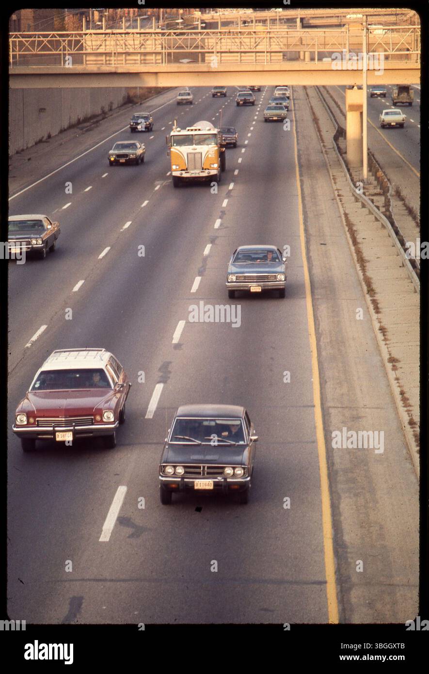 An unidentified section of freeway shows four lanes of traffic. The ...