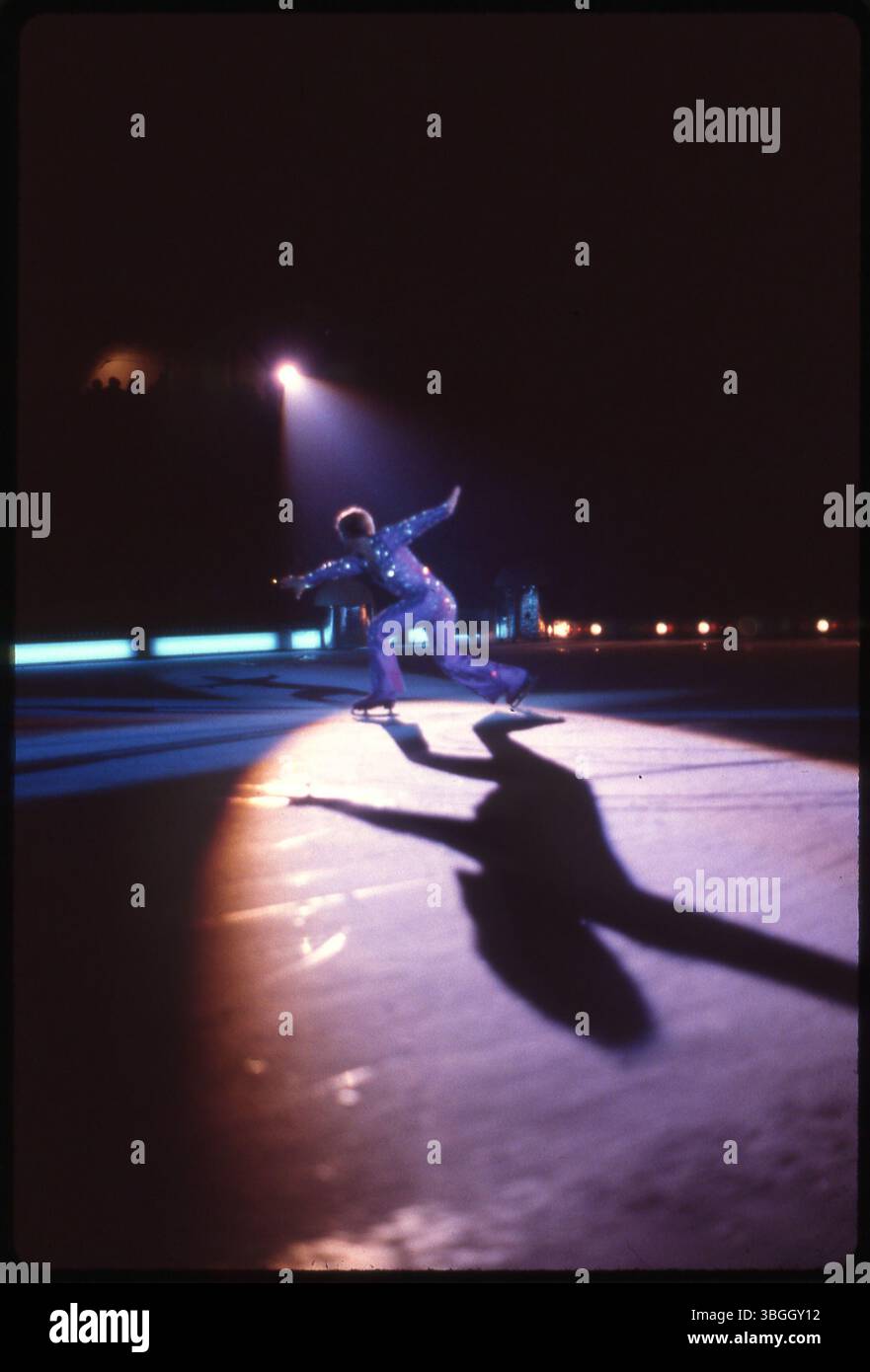 A figure skater performs on ice in a sparkly purple costume during the ...