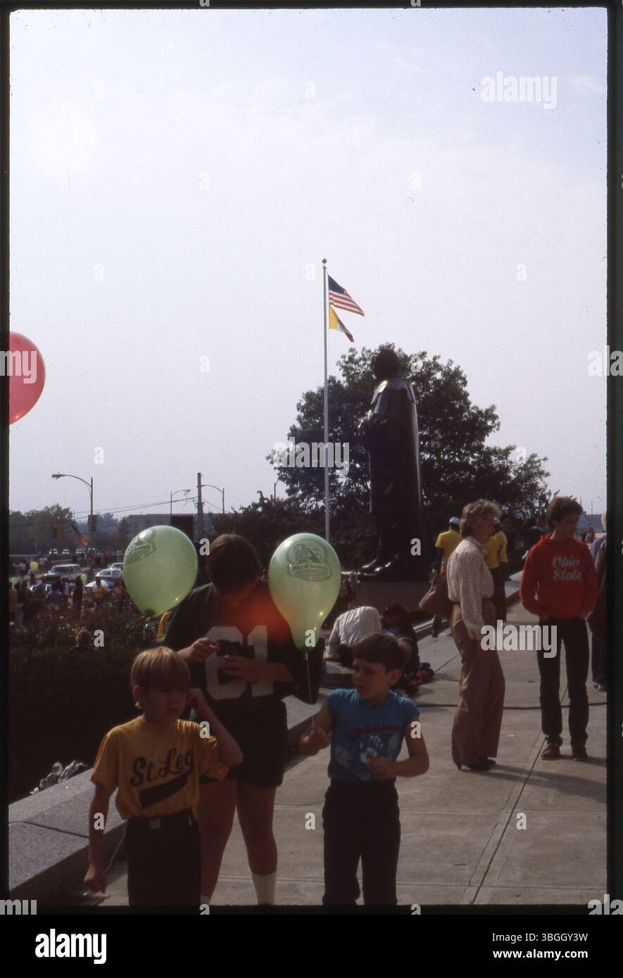 The image depicts children holding balloons with "Max & Erma's" logos ...