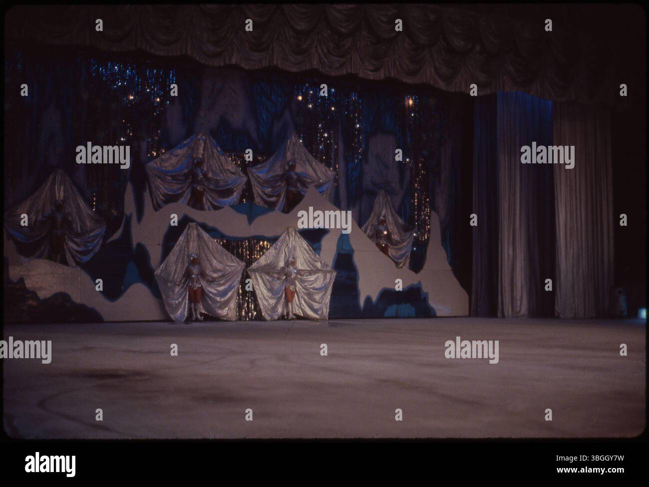 Figure skaters in silver snowflake costumes perform at the Ice Follies ...