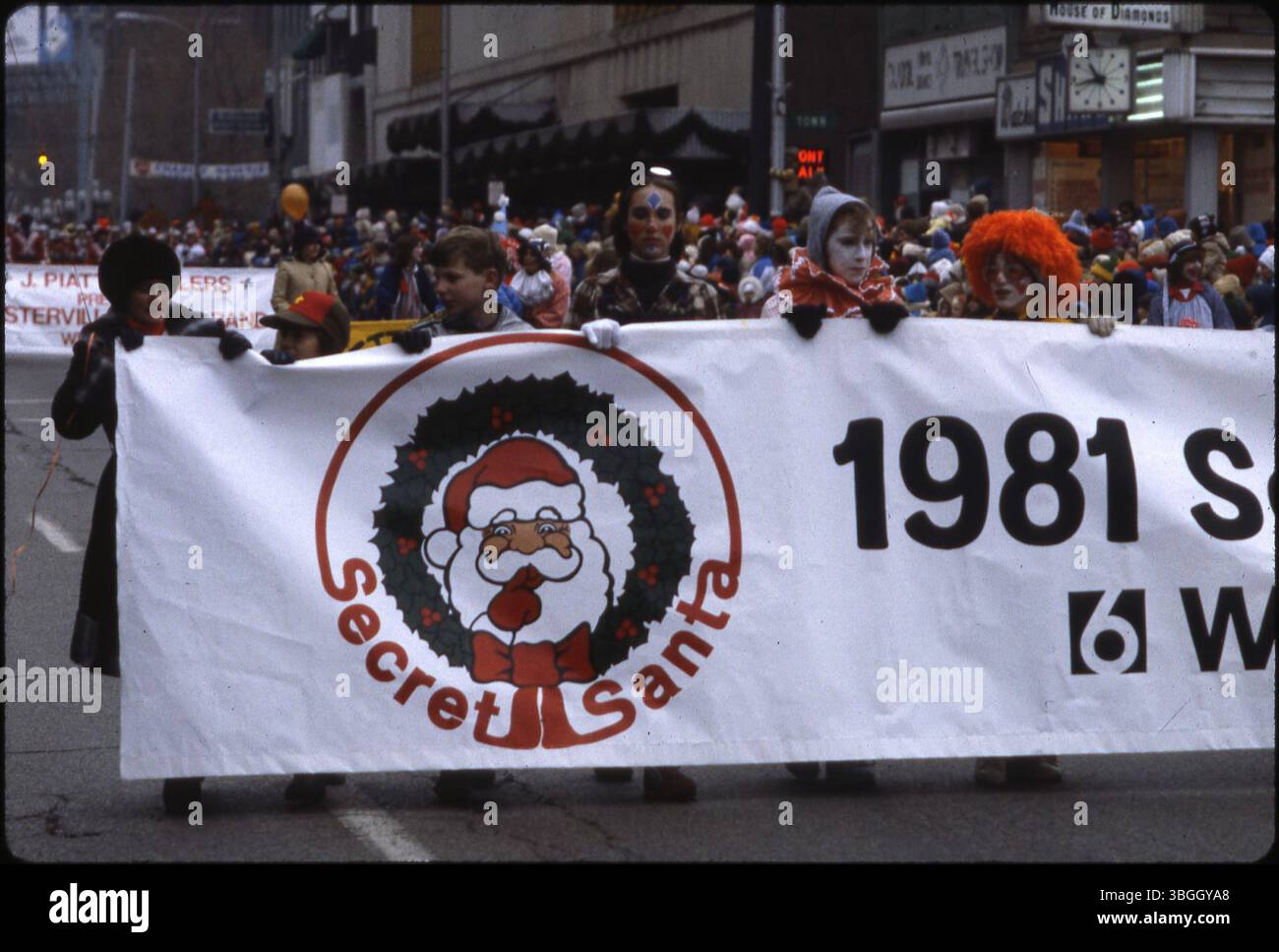 Children in costume carry a 'Secret Santa' banner during the 1981 ...