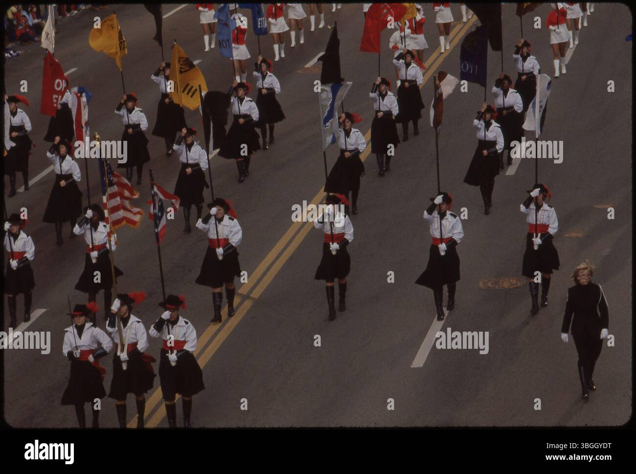 A group of unidentified individuals carries various flags during a ...