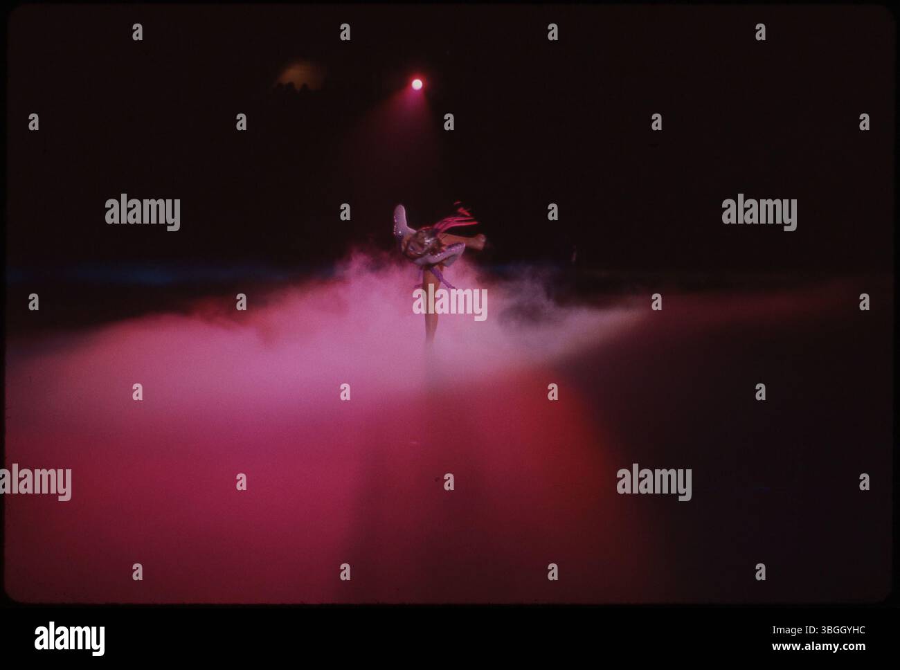 A female figure skater performs an elegant routine on one foot at the ...