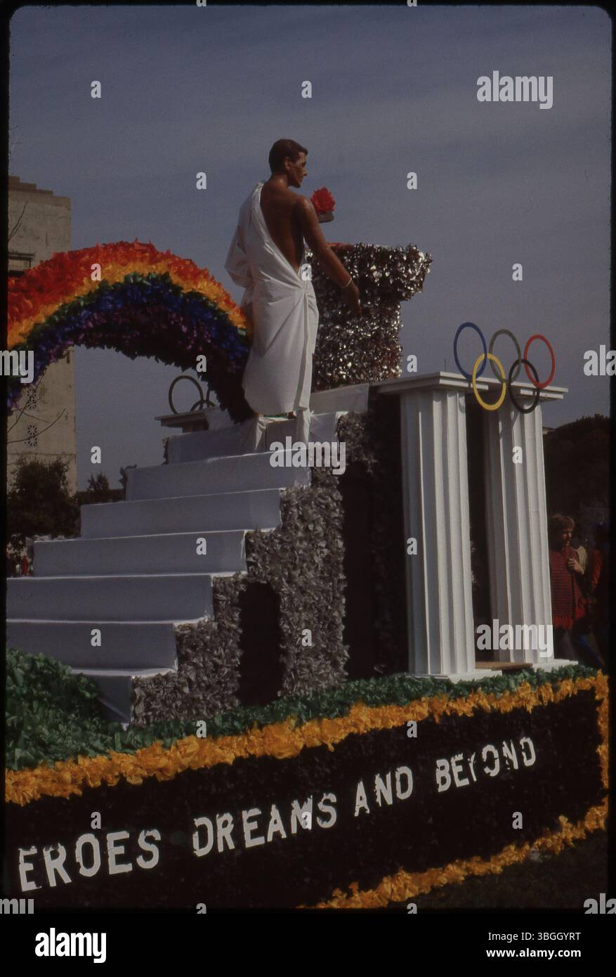 An Olympics-themed float with a staircase, rainbow, and Olympic rings ...