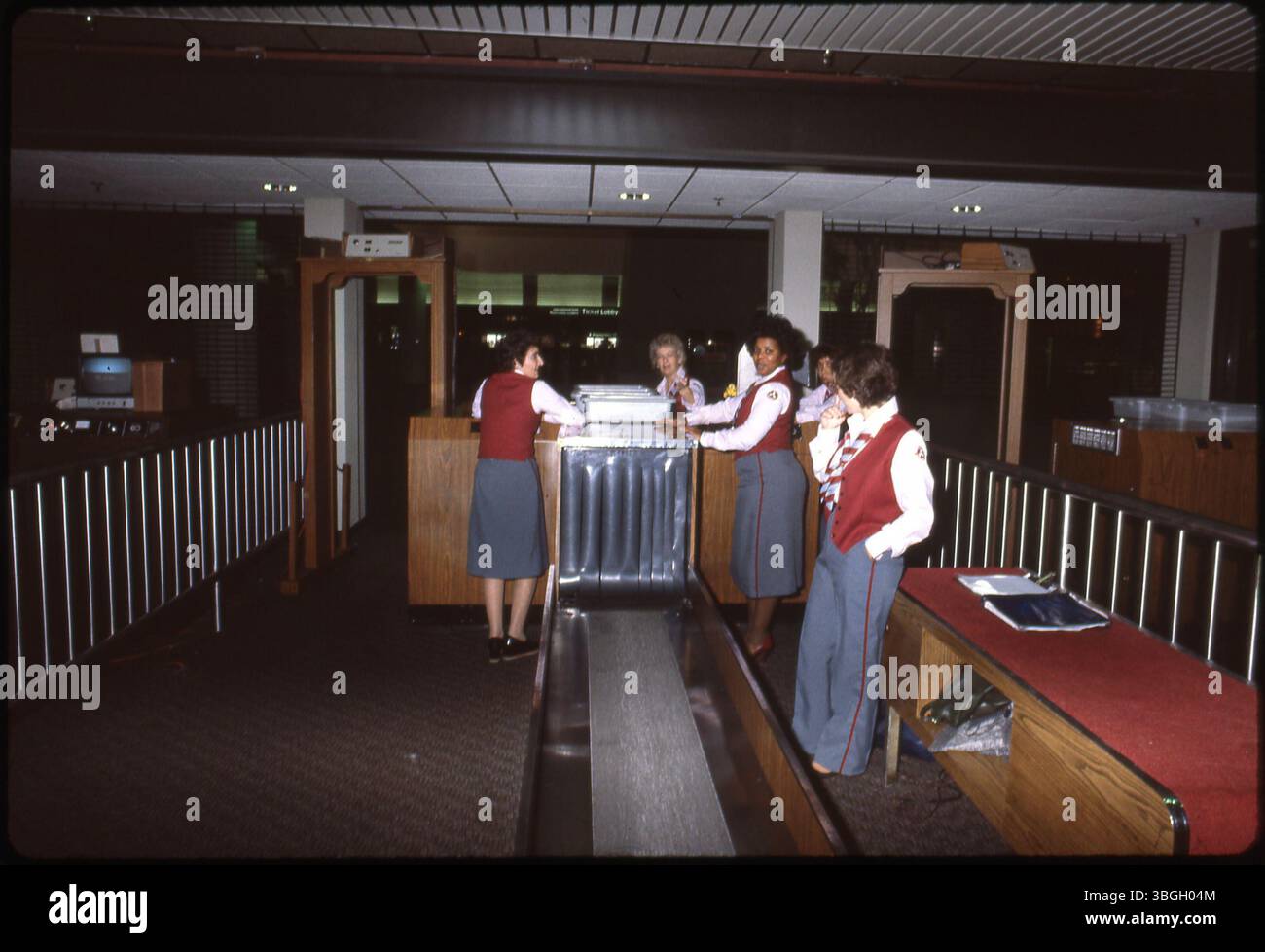In 1980, airport security personnel are seen at the security gate of ...