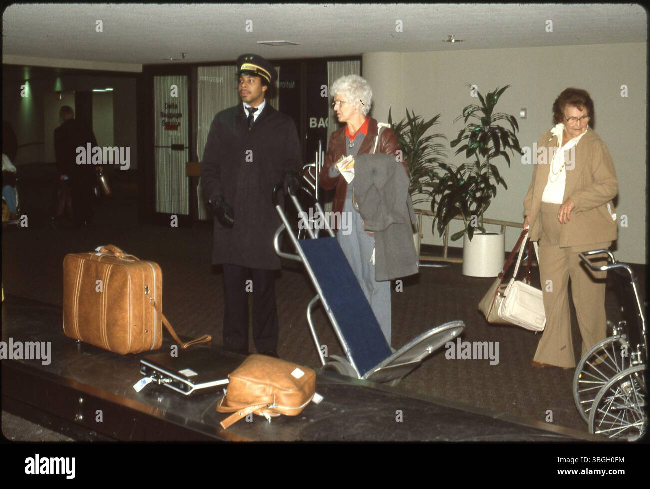An unidentified Skycap porter stands beside a baggage carousel at Port ...
