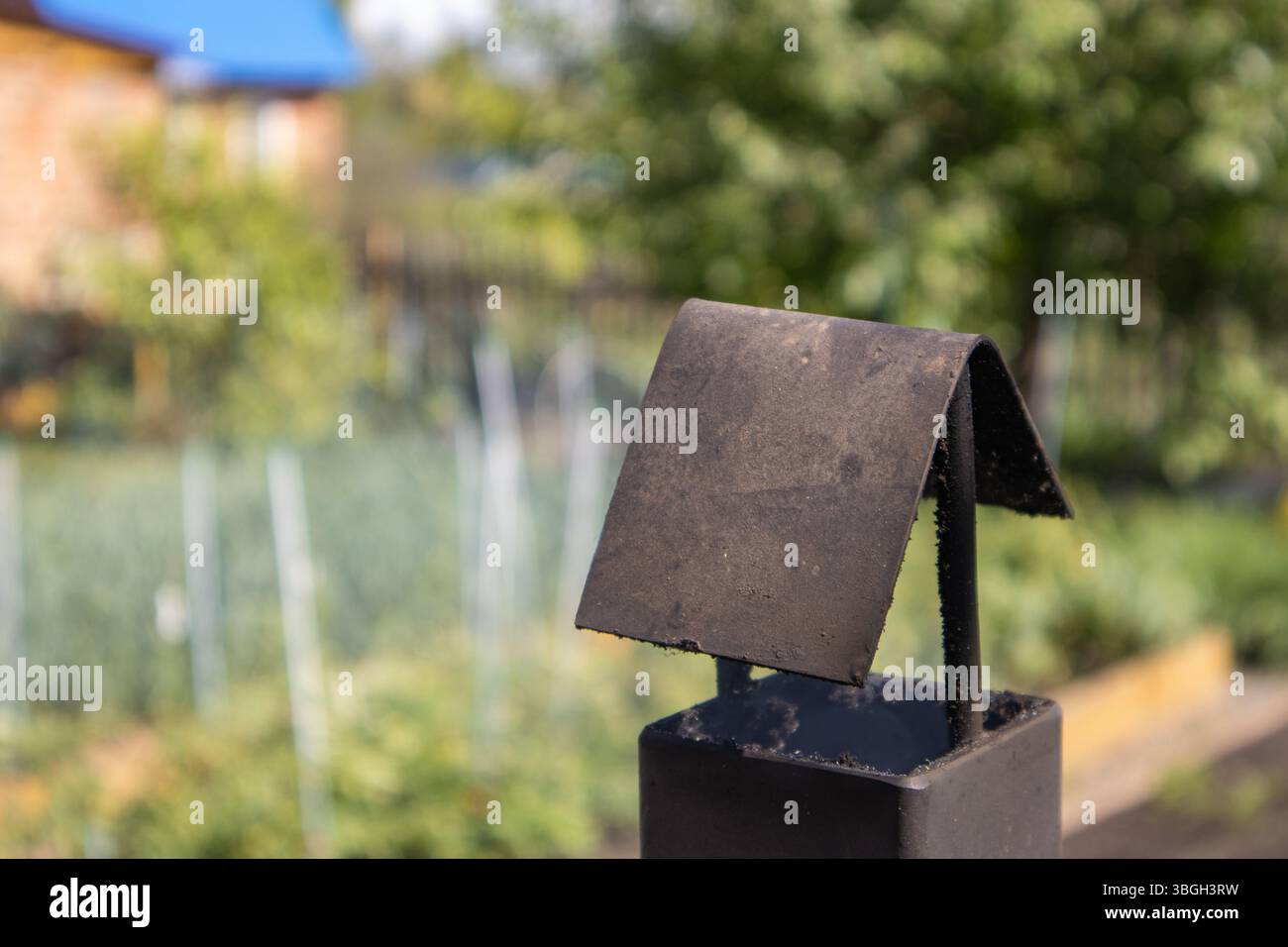 Vintage iron pipe chimney with corner umbrella. Close-up of a pipe from ...