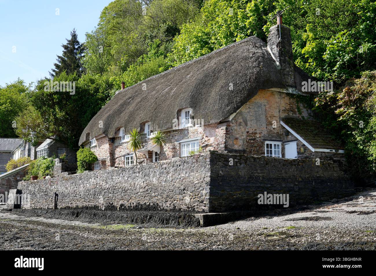 The historic thatched Smugglers Cottage overlooking The River Dart ...
