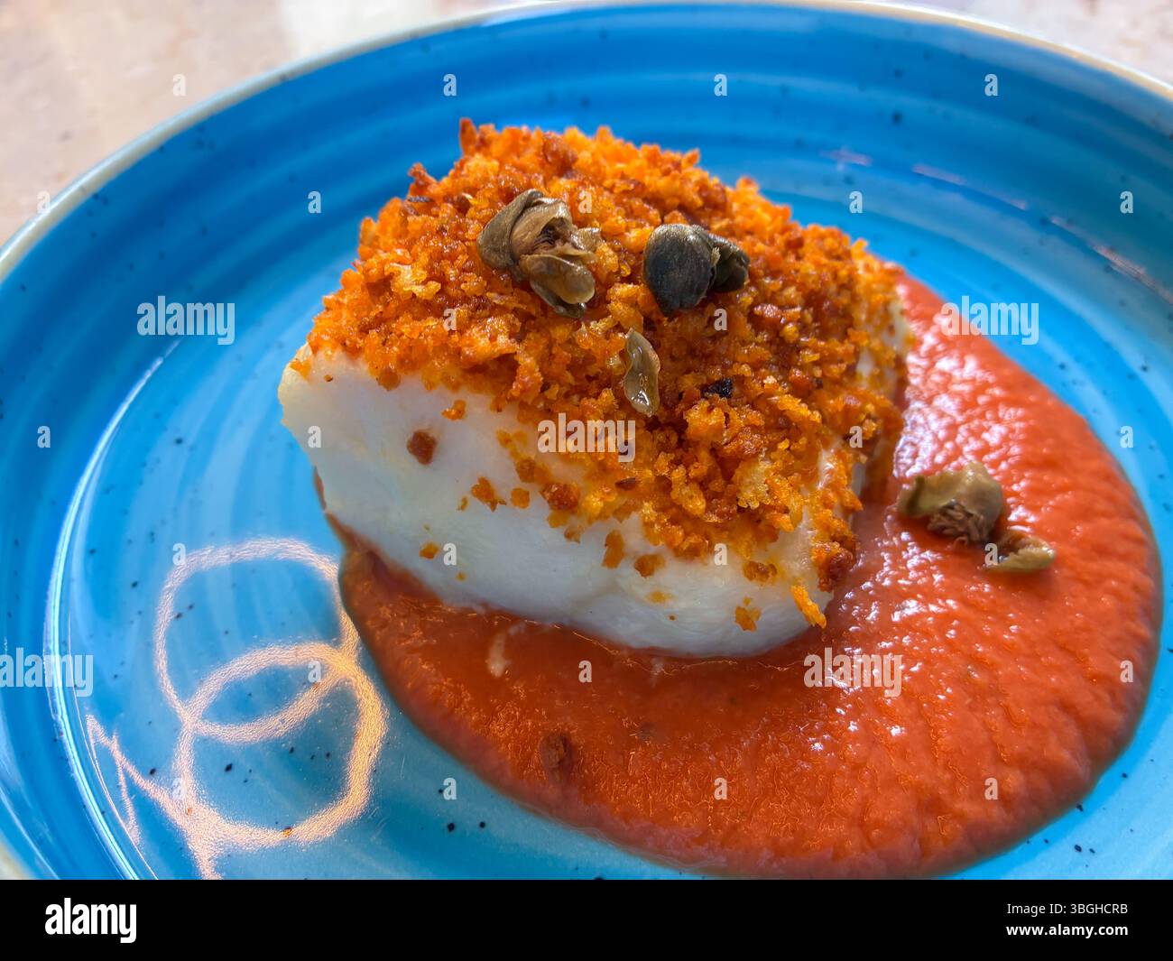 Cod with sauce dish in restaurant, Sicily Stock Photo - Alamy