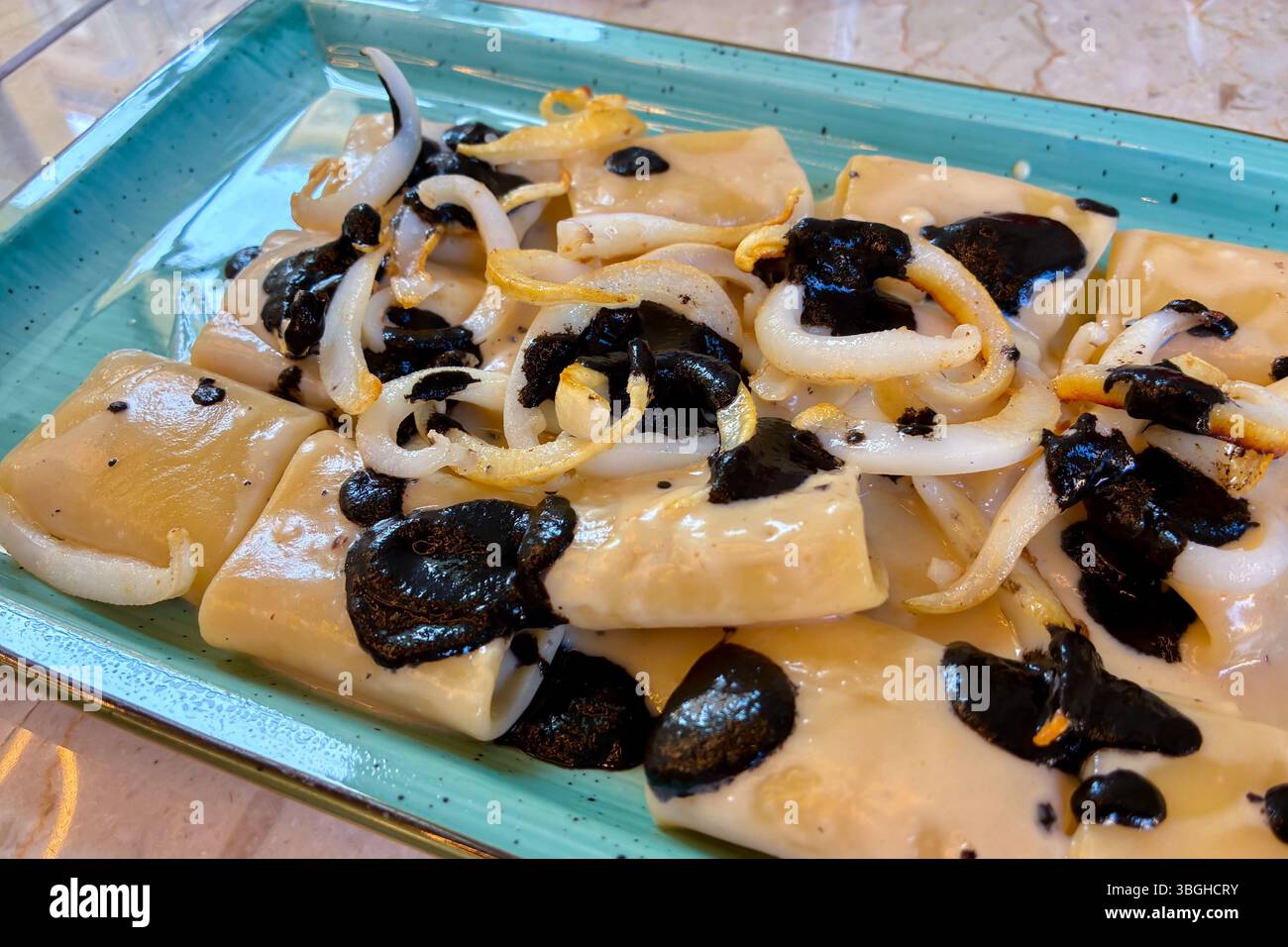 Rigatoni with squid and squid ink, Sicily Stock Photo - Alamy