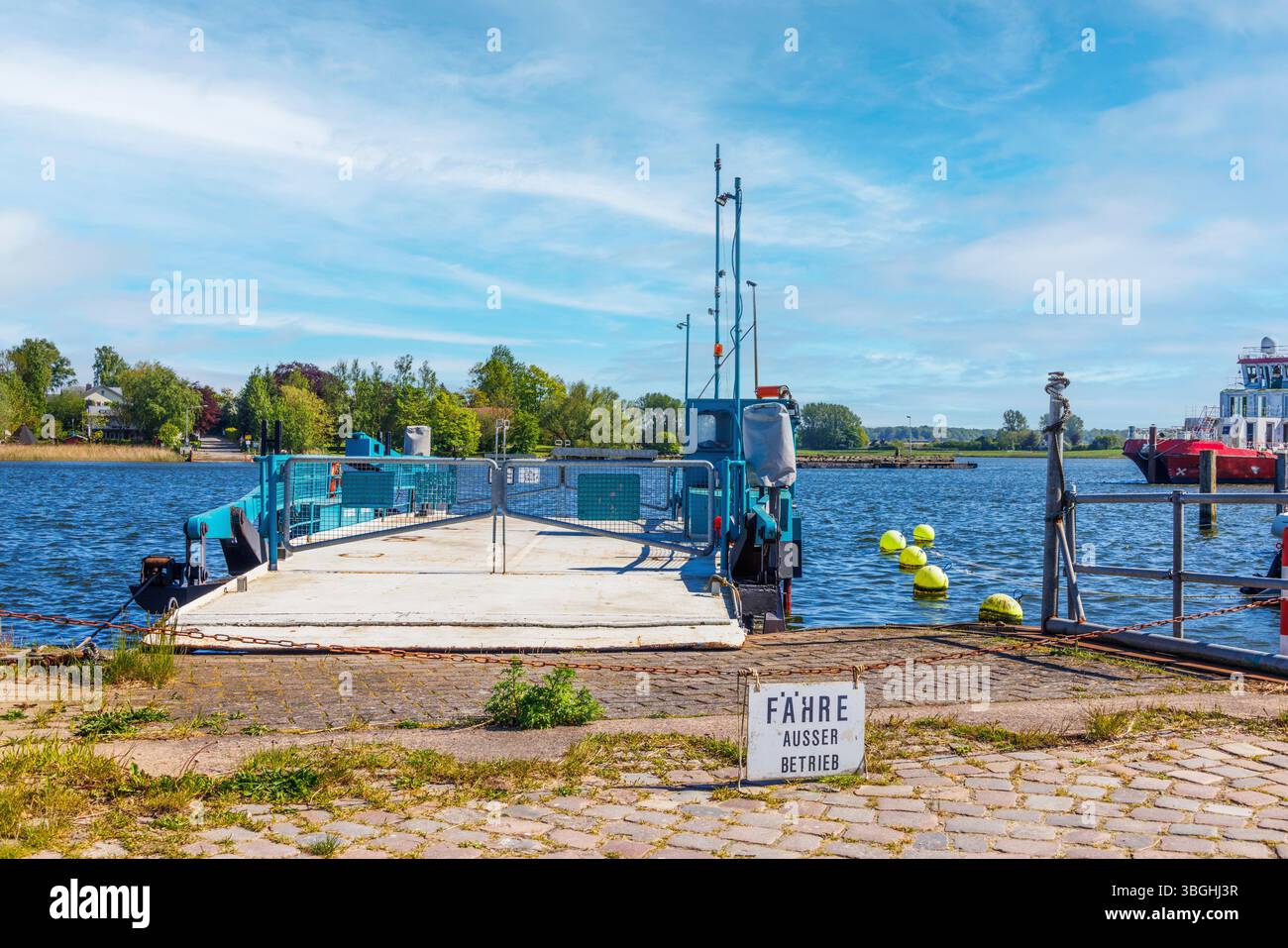 Empty ferry landing stage with closed gate and sign in german language ...