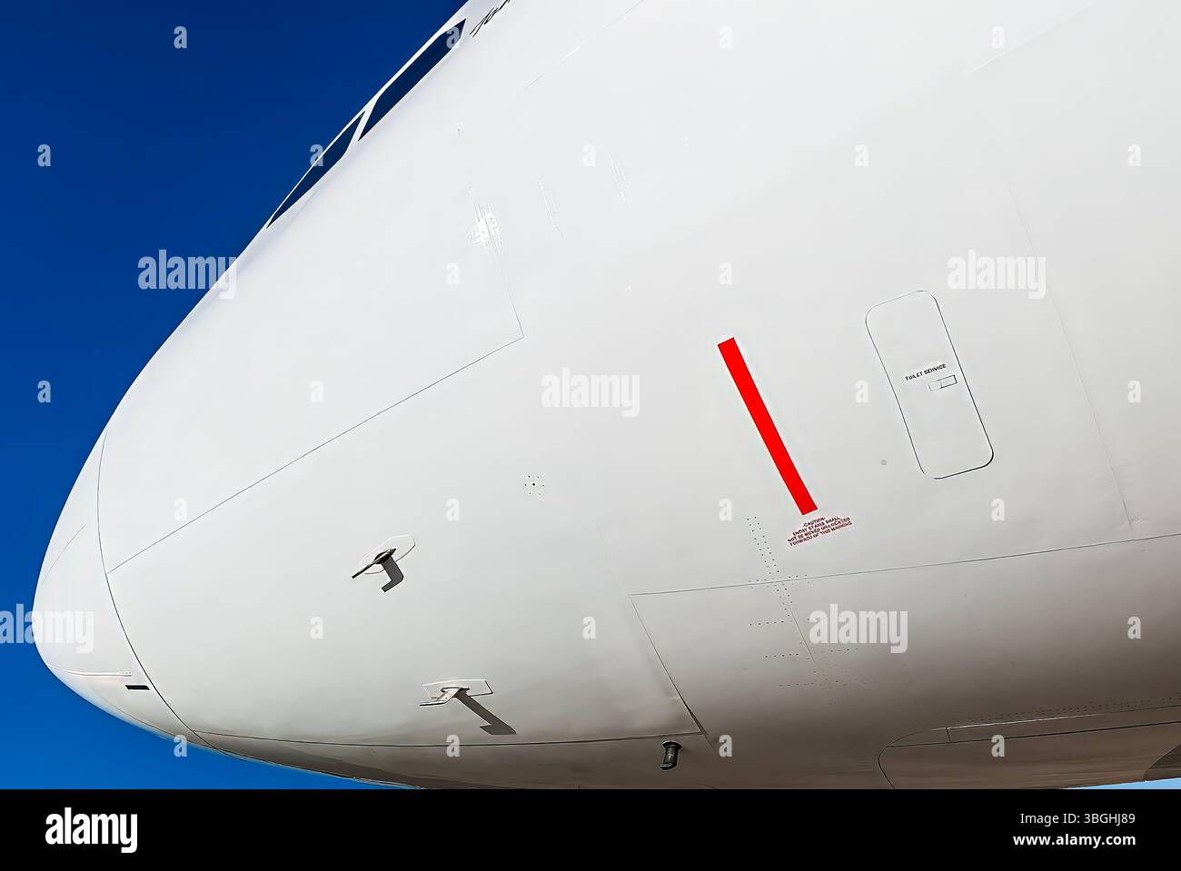 A commercial cargo aircraft rests on the tarmac of a bustling ...