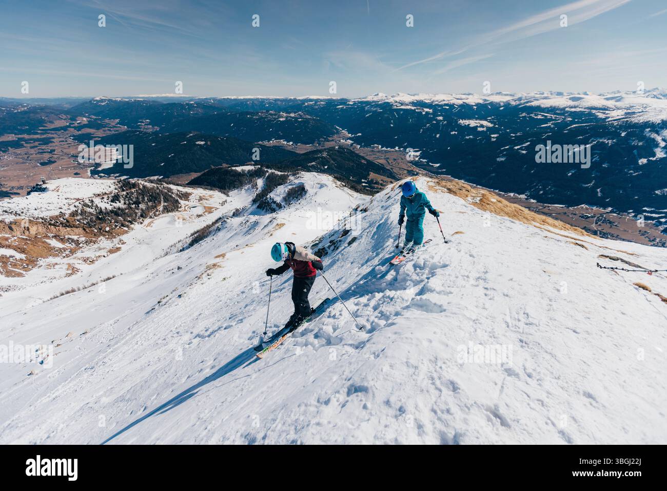Family skiing off piste in front of alpine panorama hi-res stock ...