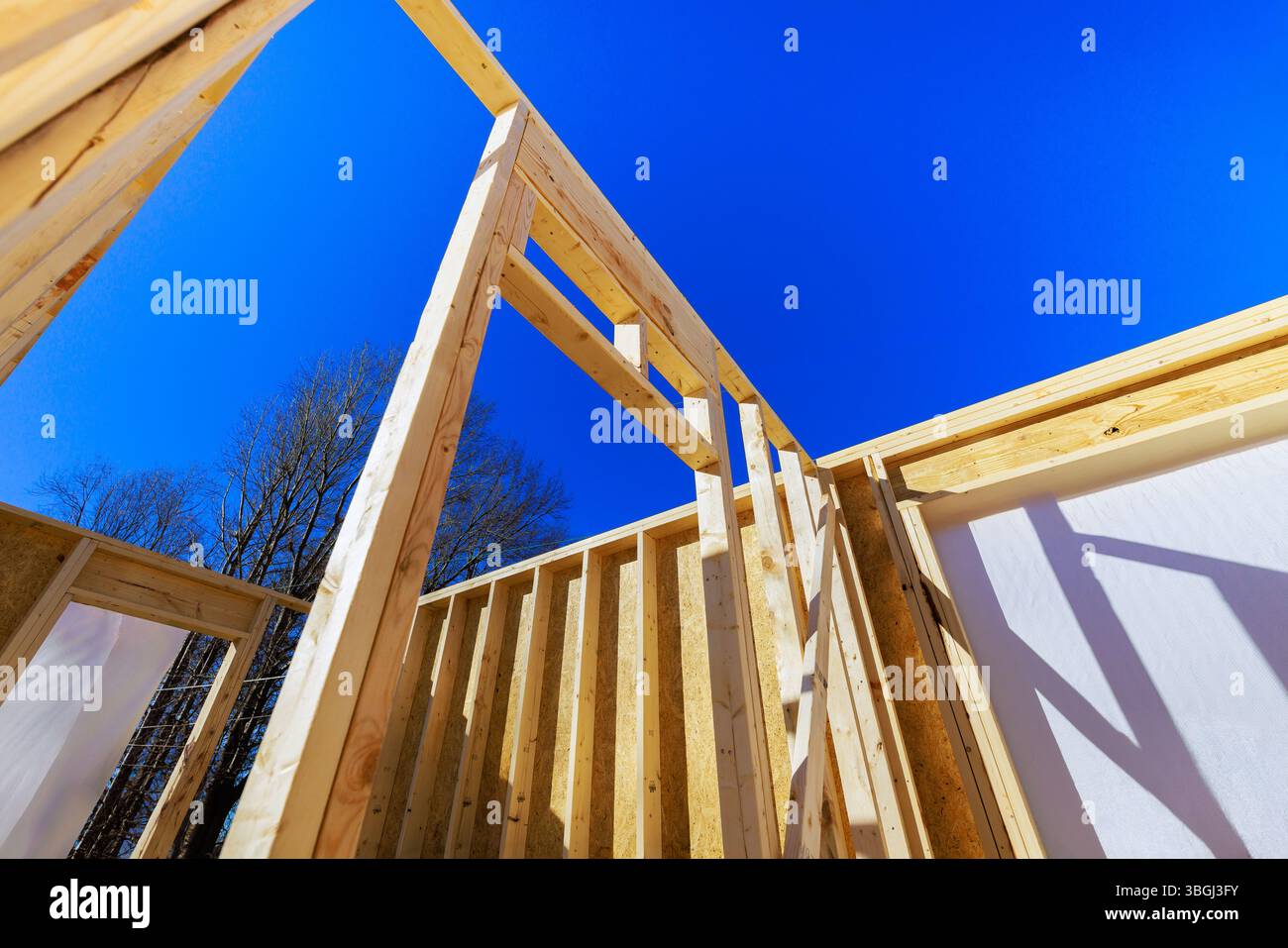Workers are assembling wooden beams structure with beams supporting frame Stock Photo - Alamy