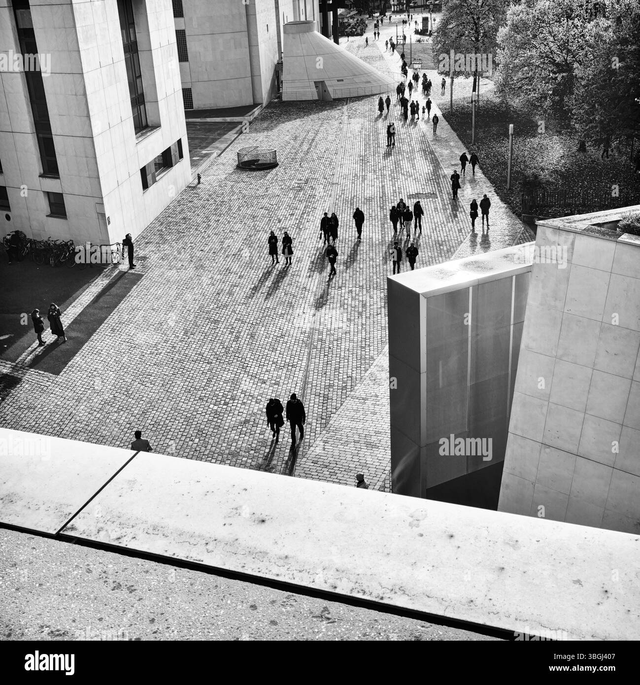 Black and white photograph, silhouetted people walking towards ...