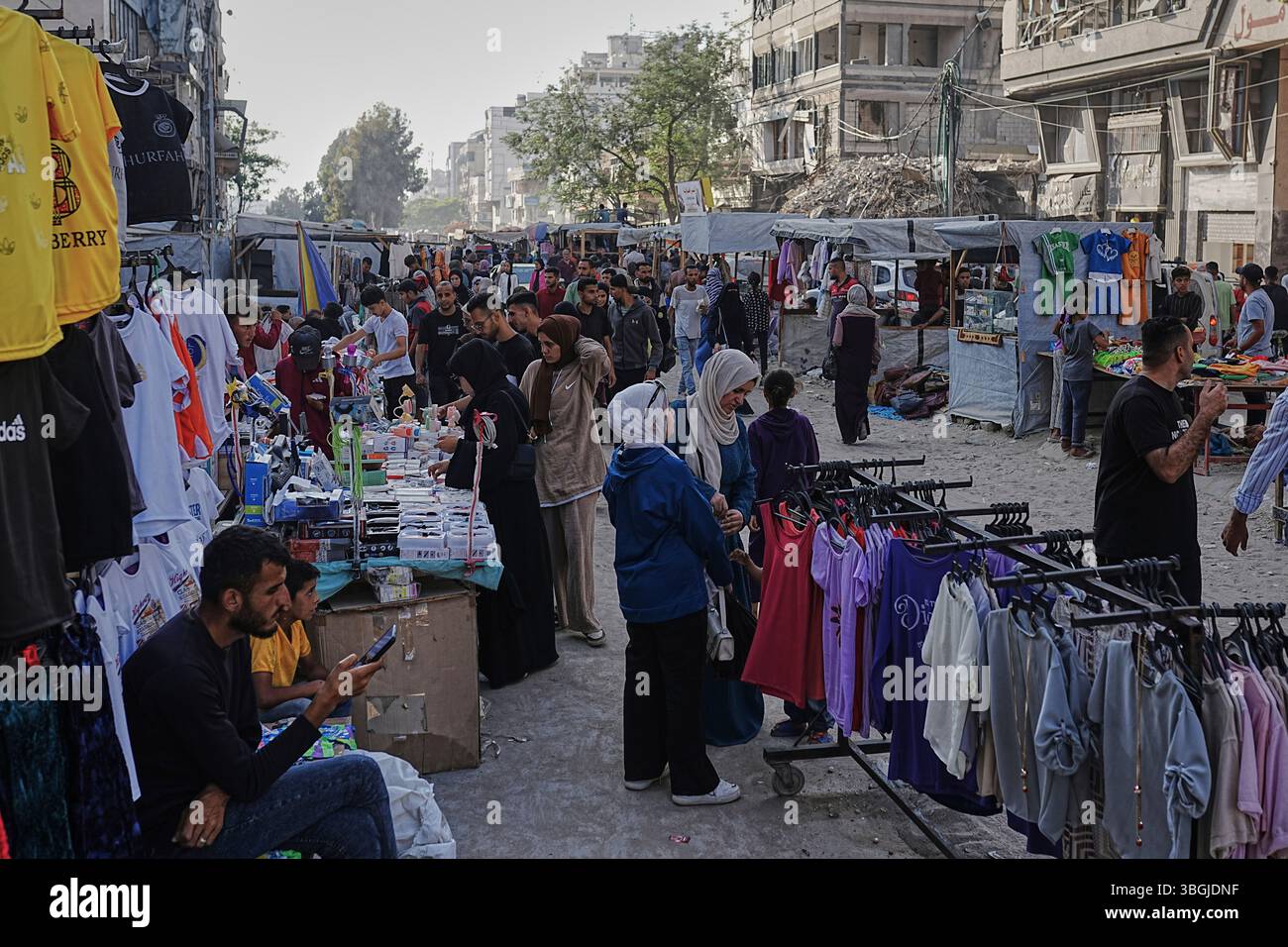Palestinians walk trough a market ahead of the Muslim holiday of Eid al ...