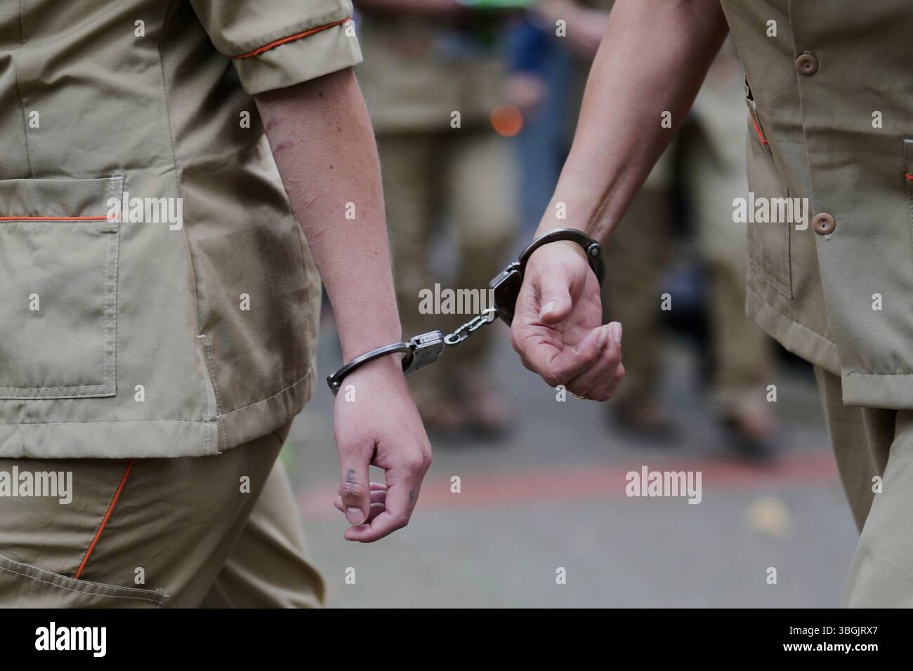 Inmates arrive to a park in handcuffs to participate in a new program ...