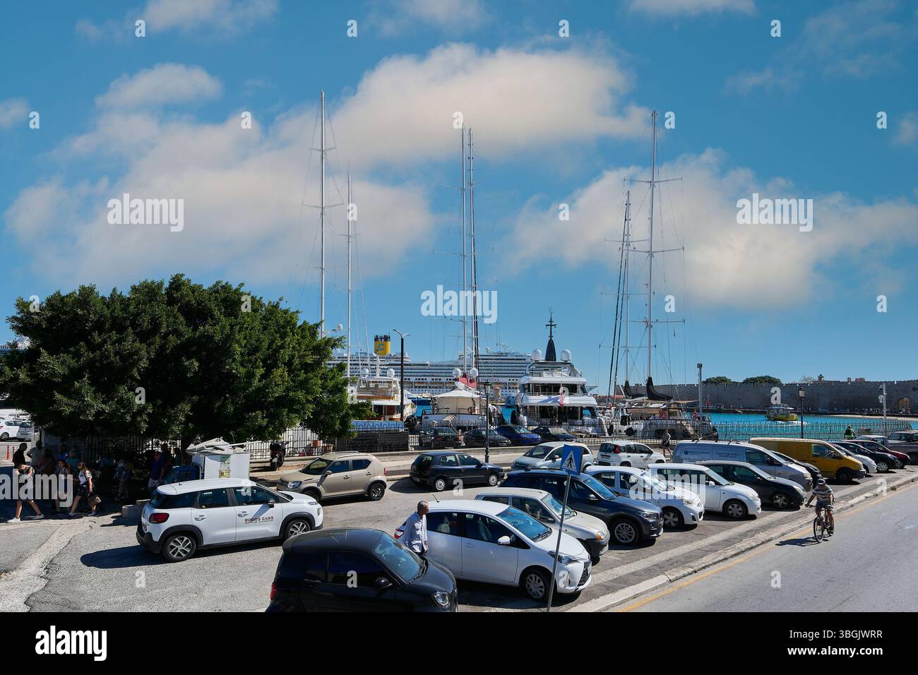 Rodas.Greece - june 05, 2025: A parking lot with various cars and a ...