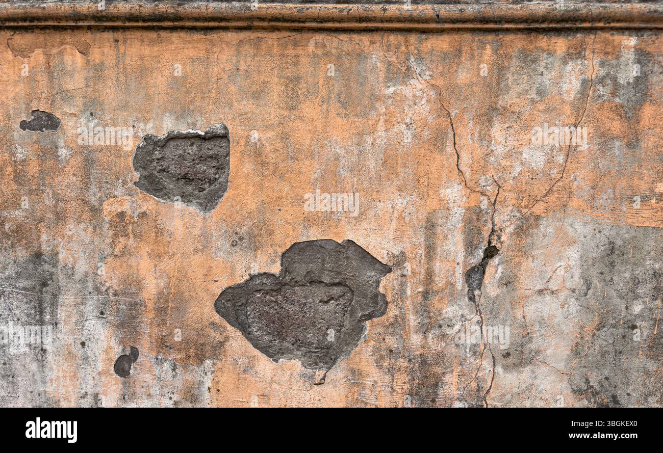 Damaged old plaster wall with cracks, peeling paint, exposed concrete ...