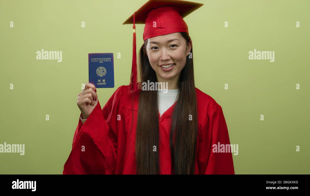 Woman in red graduation gown holding korean passport against yellow ...