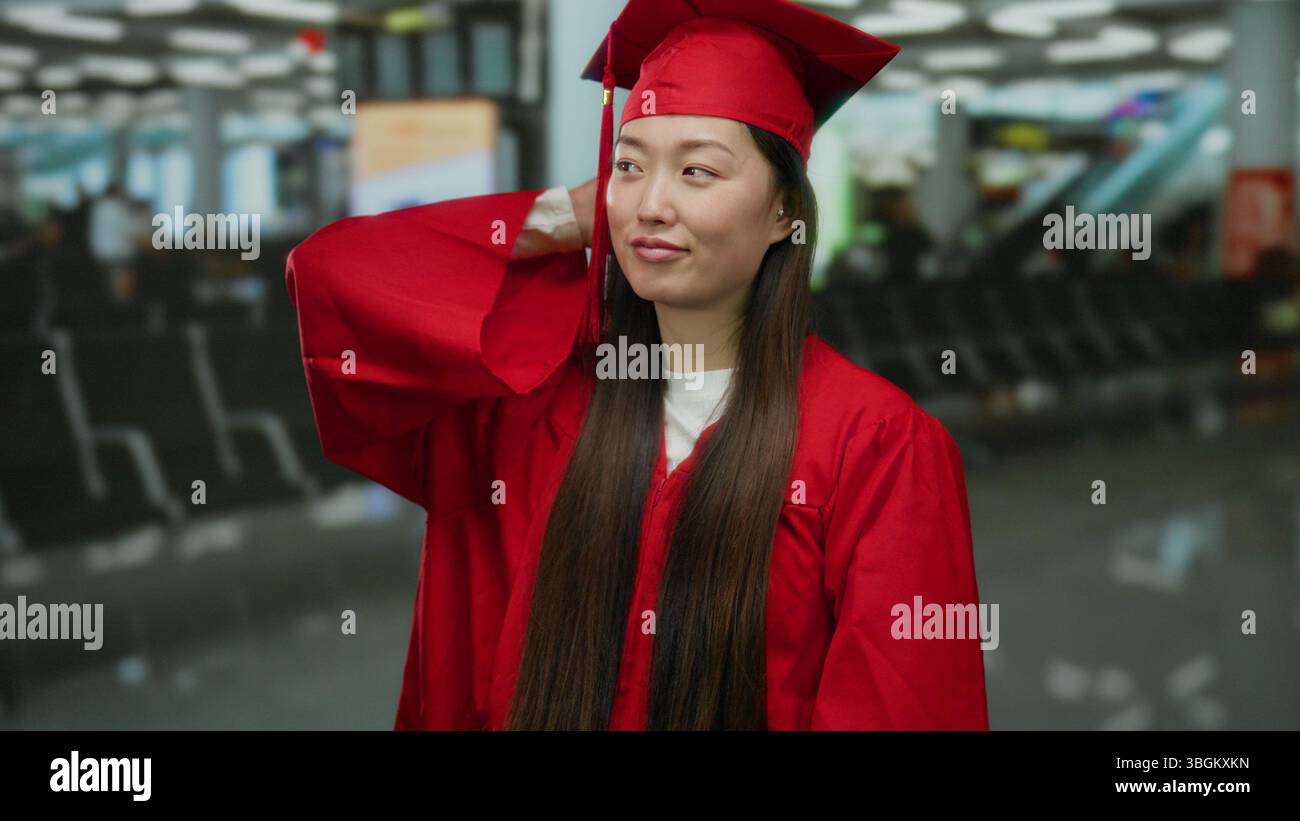 Woman in graduation cap and gown standing in airport terminal, wearing ...