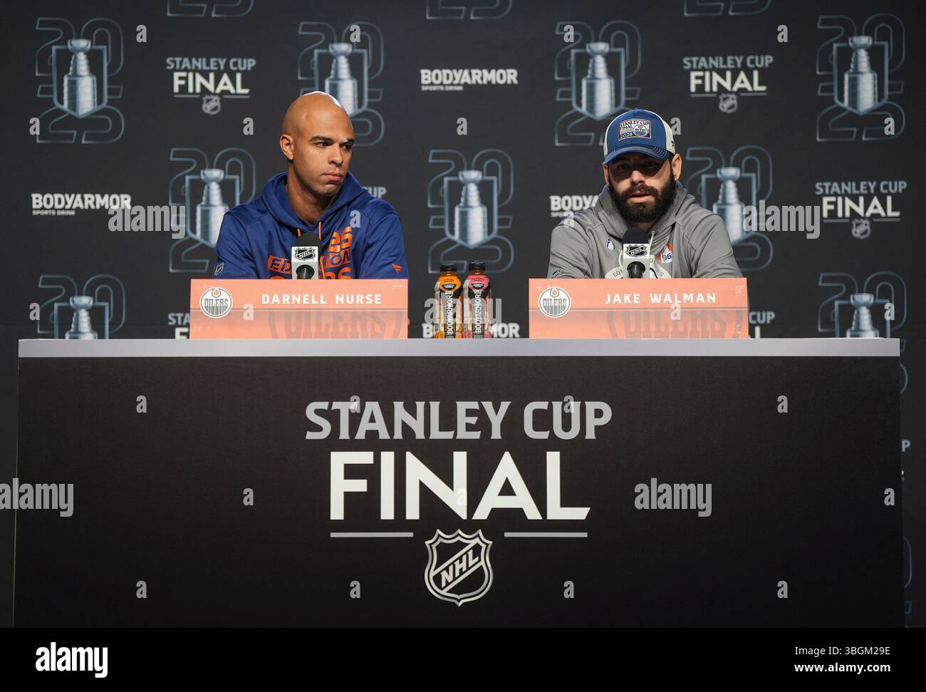 Edmonton Oilers' Jake Walman, right, speaks as Darnell Nurse listens ...