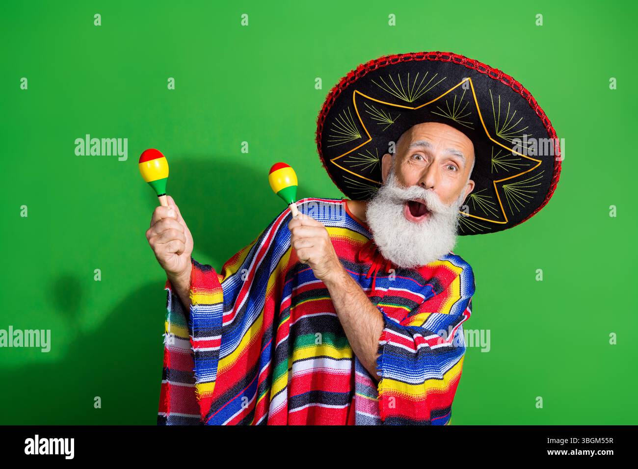 Charismatic senior man celebrating in colorful traditional Mexican ...