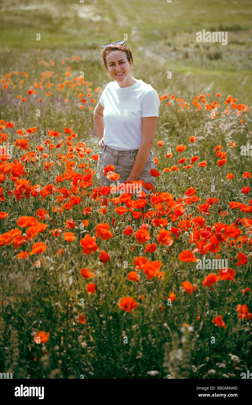 Woman stands amidst field wildflowers hi-res stock photography and ...