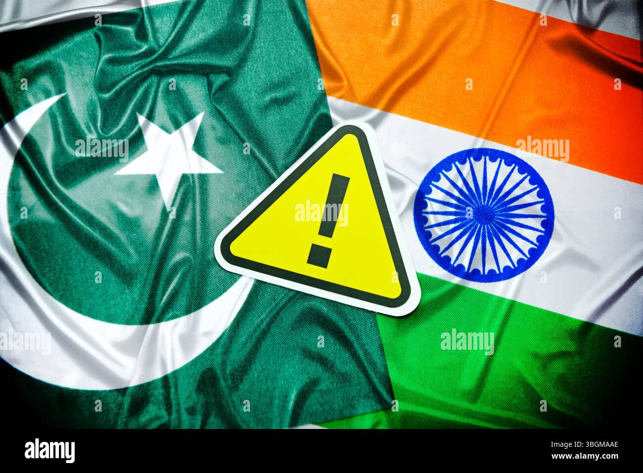 Danger sign with exclamation mark on the flags of Pakistan and India ...