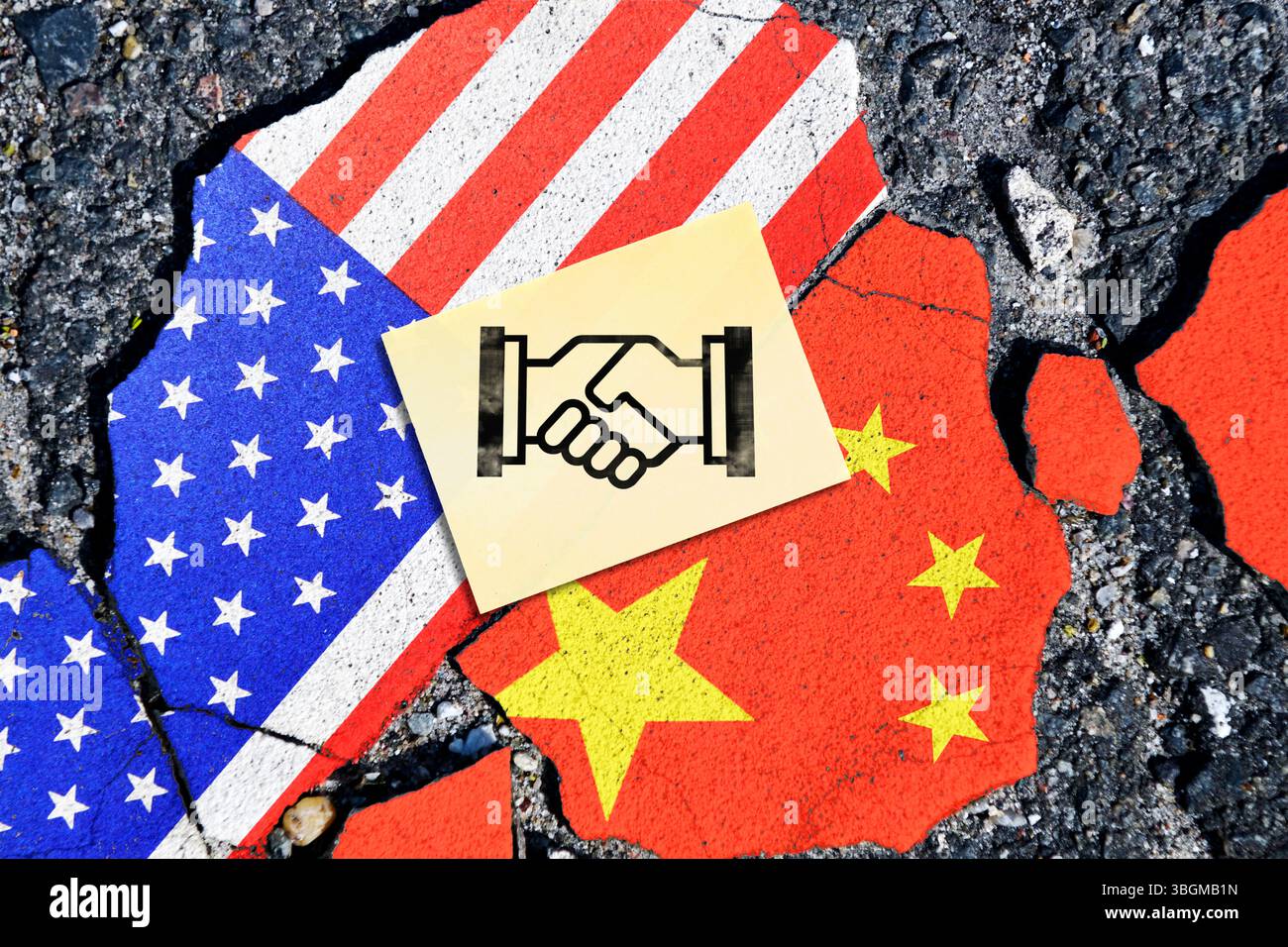 Flags of USA and China on broken ground with note and handshake symbol ...