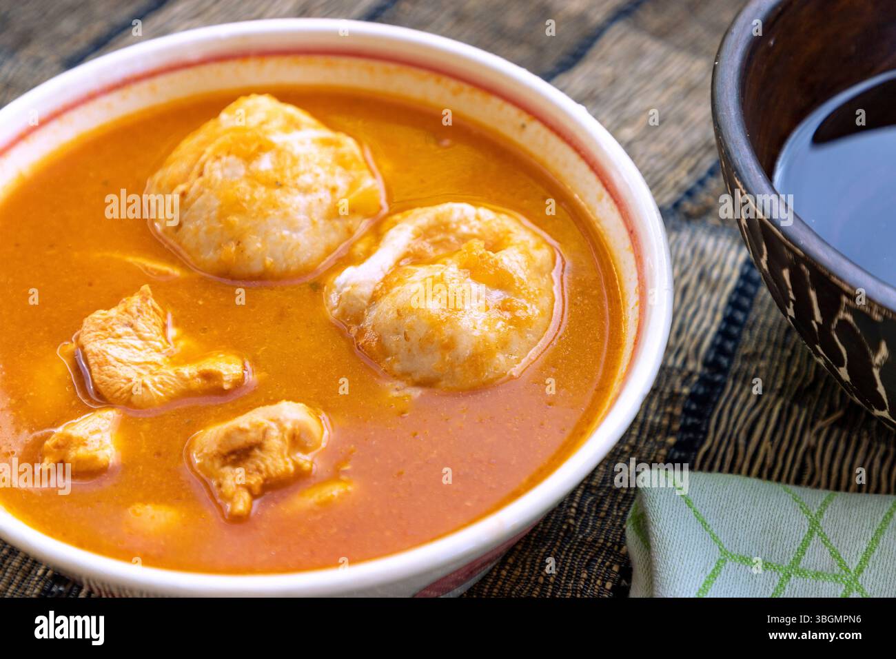Light soup with chicken and fufu with water bowl and towel for washing ...