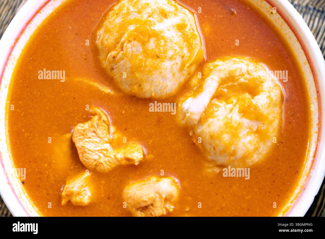 Light soup with chicken and fufu, West African soup dish, served in ...