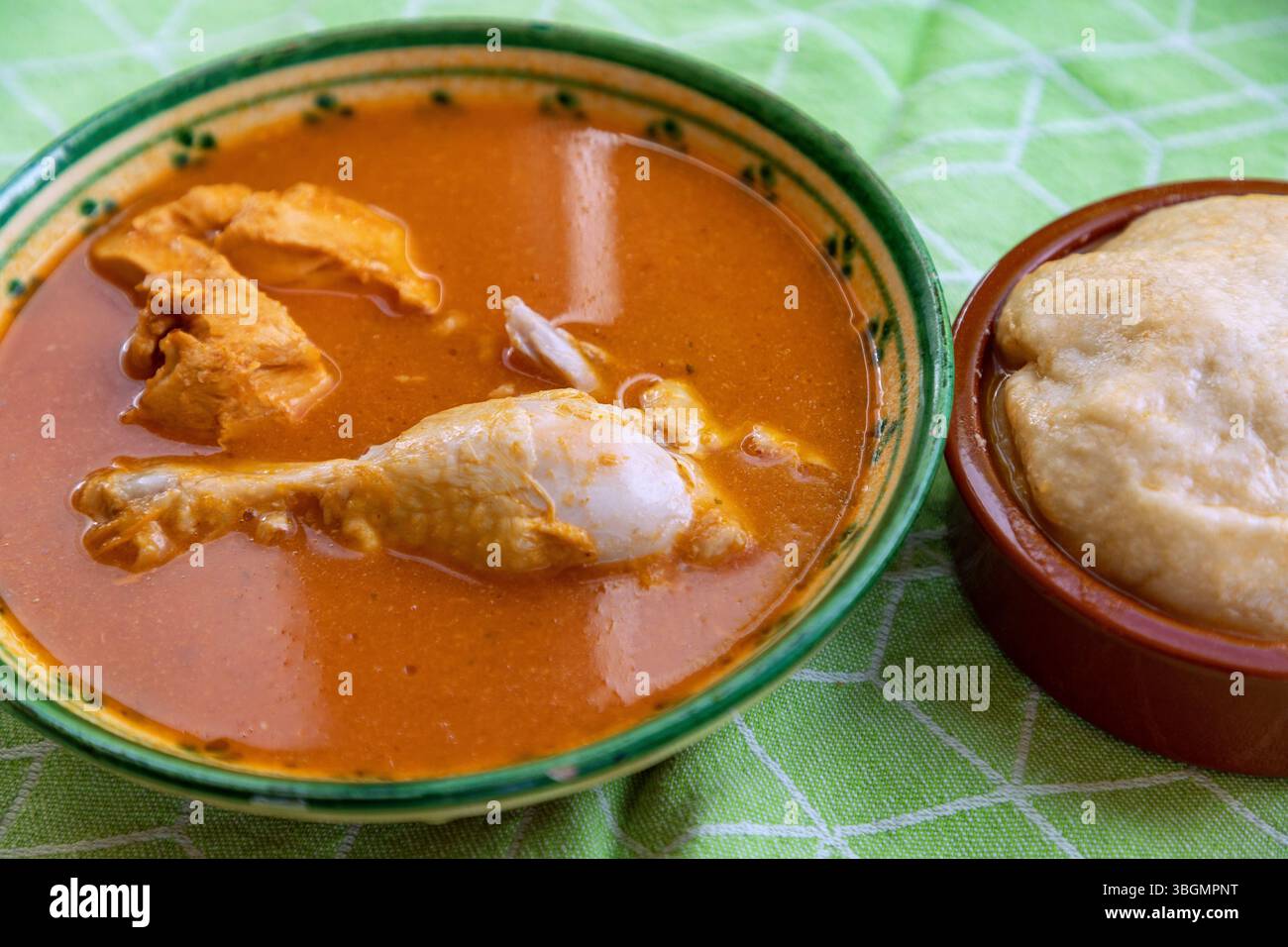 Light soup with chicken and fufu, West African soup dish, served in ...