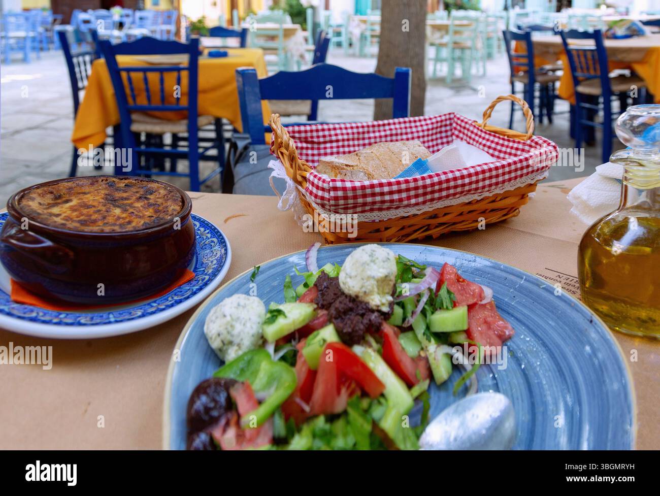 Moussaka and Greek salad with feta balls and black olive paste, served ...