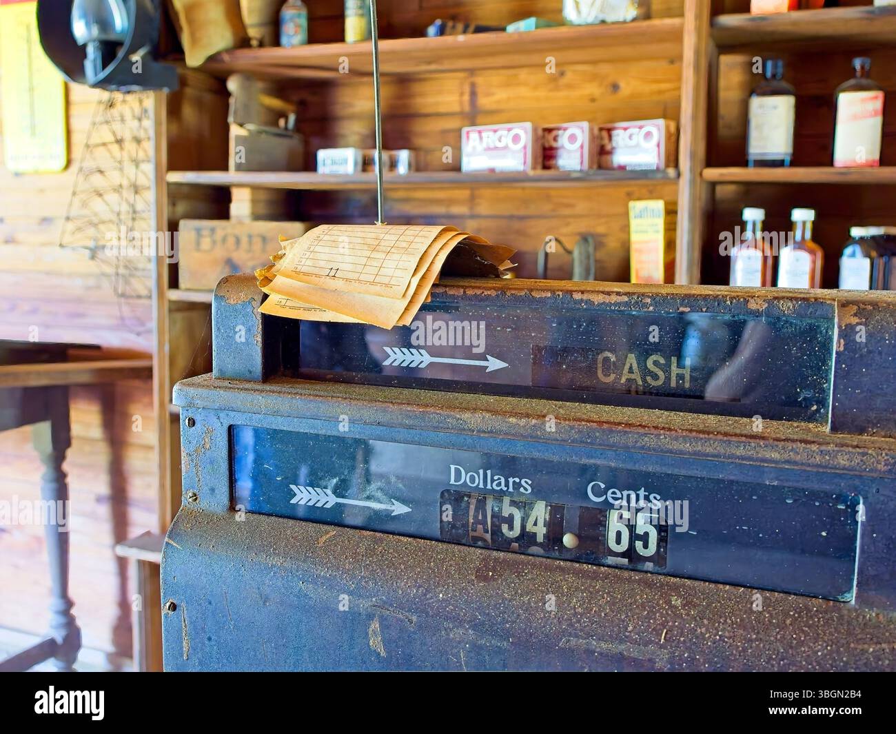 Sales receipt spike on top of antique cash register in general store on ...