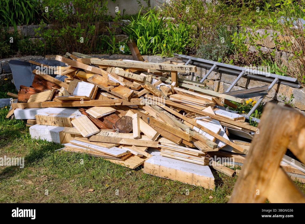 Wood waste from a roof renovation, thrown together in a pile in the ...
