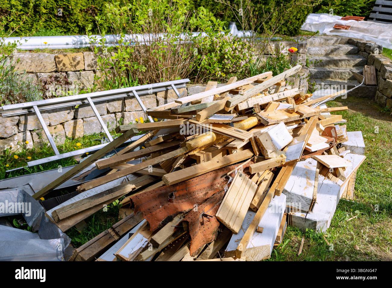 Wood waste from a roof renovation, thrown together in a pile in the ...