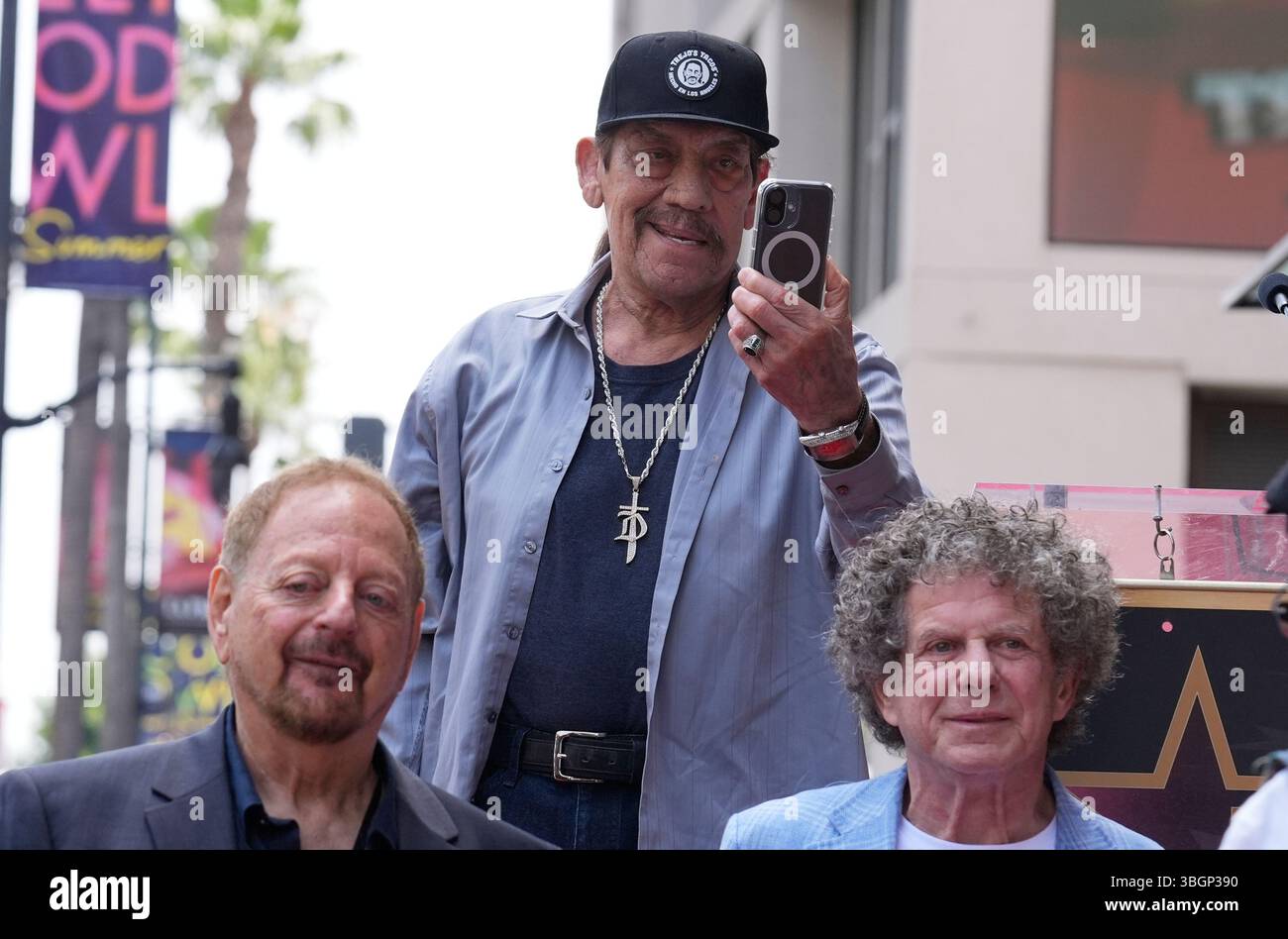 Actor Danny Trejo, center, stands behind producer Jerry Goldstein, left ...