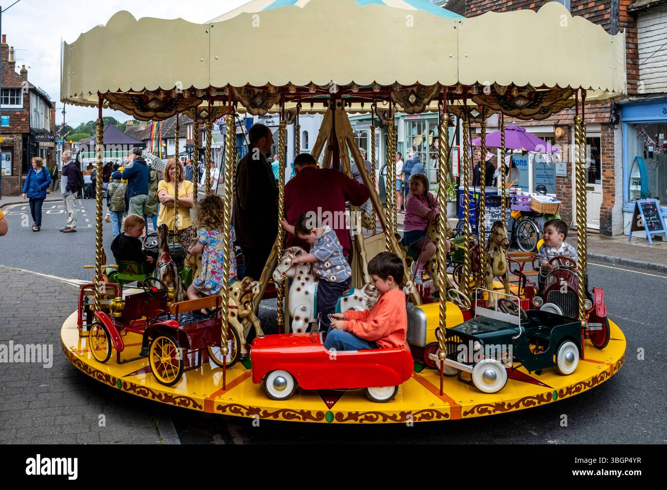 Local Children Riding On A Traditional Carousel At The Steyning Country ...