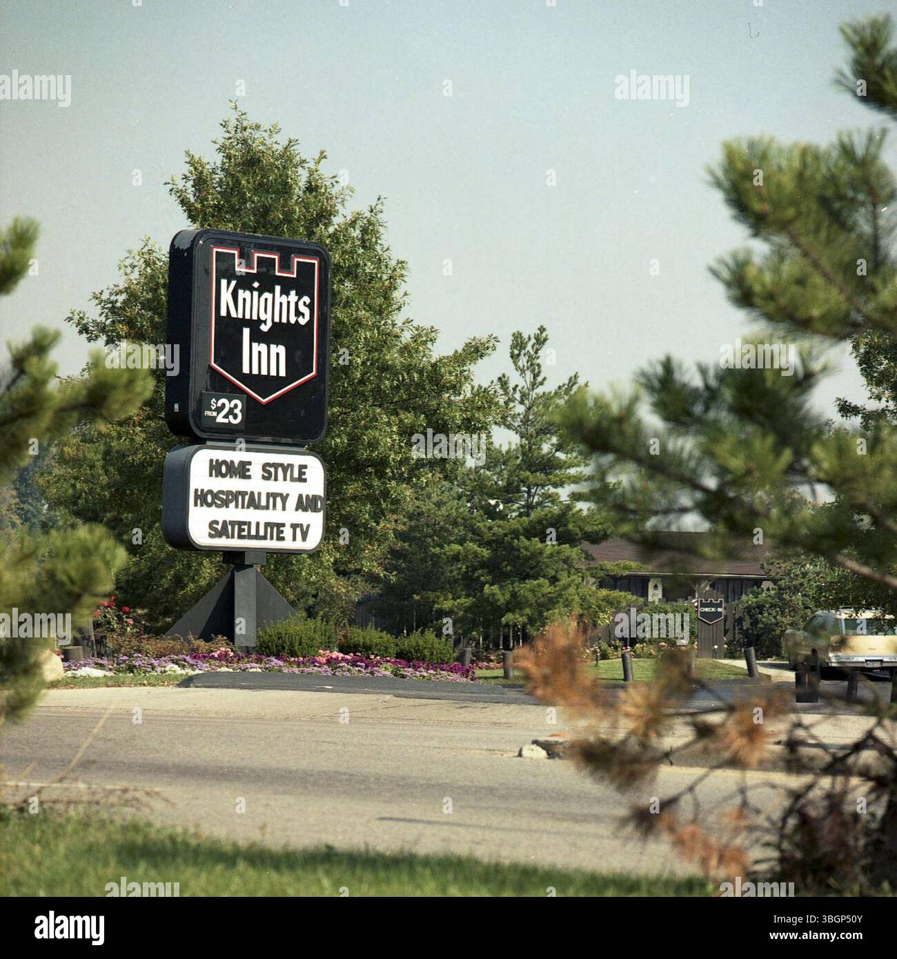 A 1977 photograph of the Knights Inn motel sign and check-in office ...
