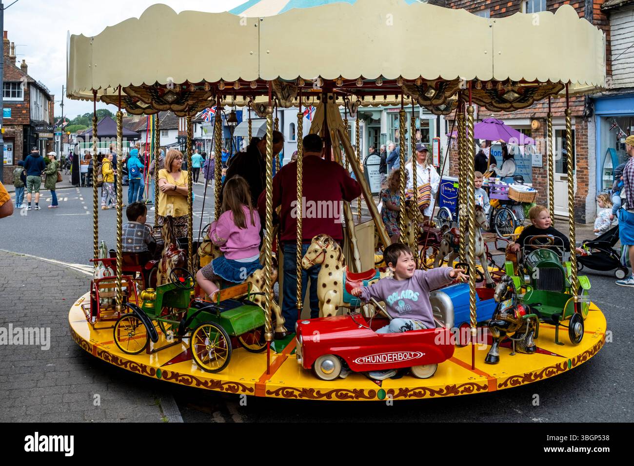 Local Children Riding On A Traditional Carousel At The Steyning Country ...