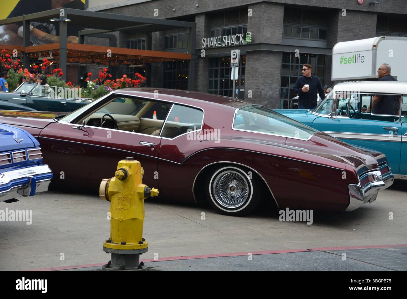 A sleek 1973 Buick Riviera lowrider on display during WAR’s star ...