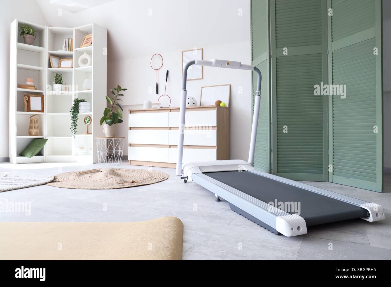 Interior of gym with treadmill, drawers and shelf unit Stock Photo - Alamy