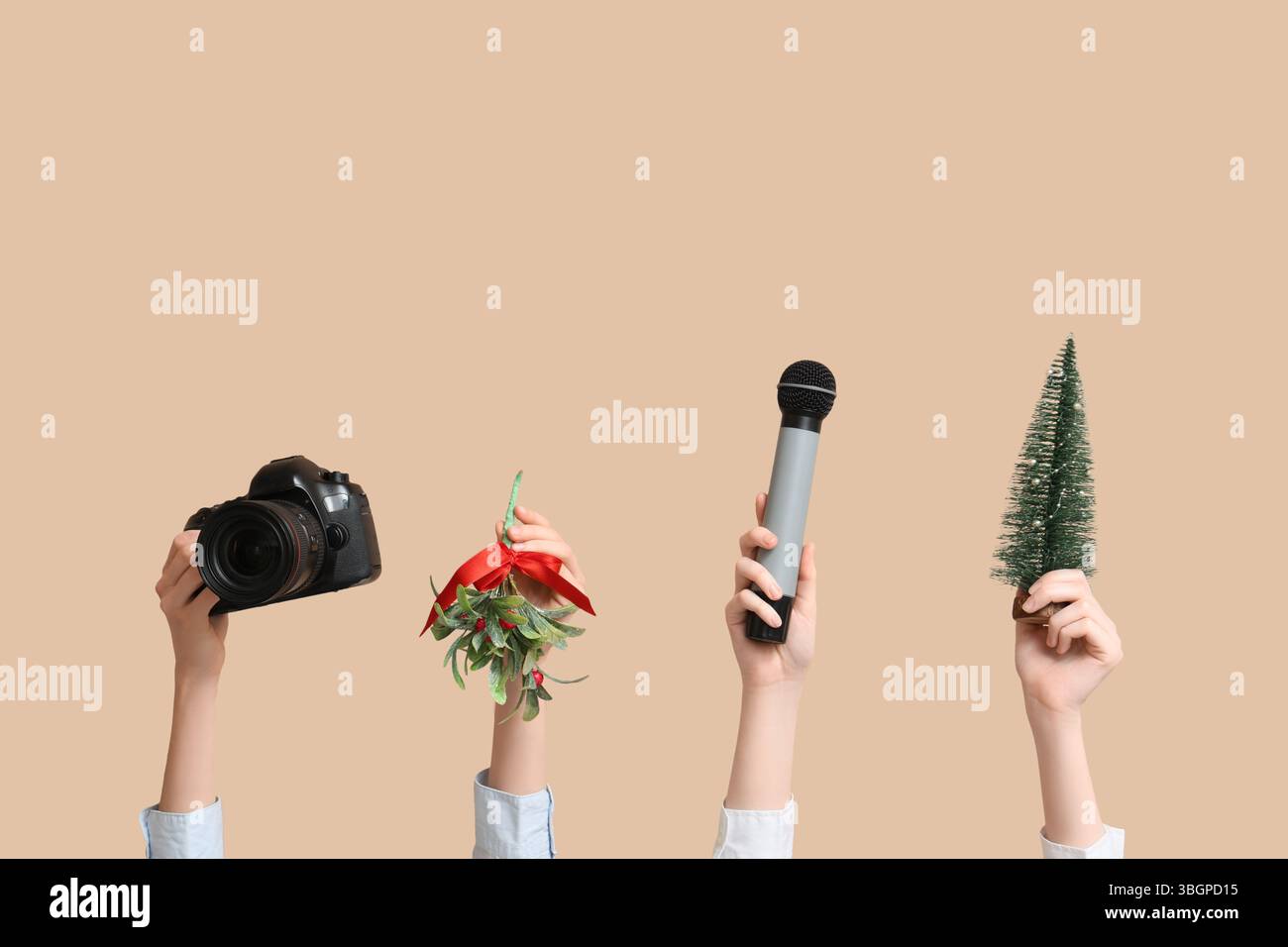 Journalist's female hands with Christmas decorations, camera and ...